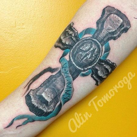 Memorial Rock Sculpted Cross with Teal Ribbon by Alin Tomoroga: TattooNOW
