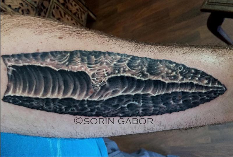 realistic black and gray obsidian tattoo by Sorin Gabor: TattooNOW